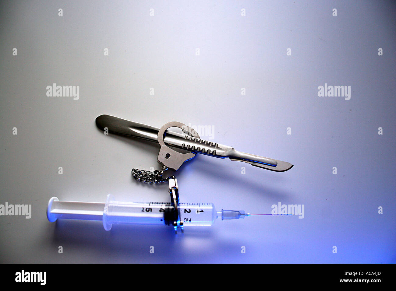 Injection with handcuffs Stock Photo - Alamy