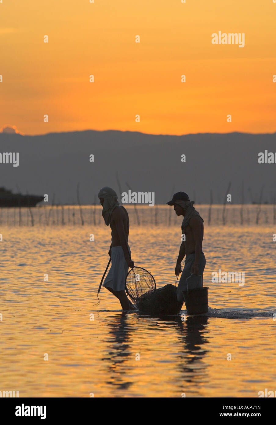 Fisherman with net in evening light, Philippines Stock Photo - Alamy