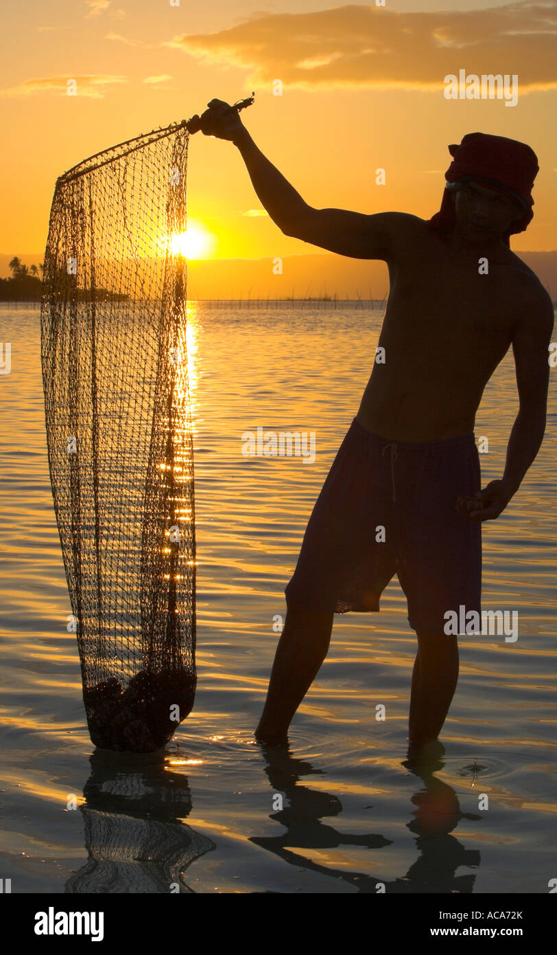 Fisherman with net in evening light, Philippines Stock Photo - Alamy