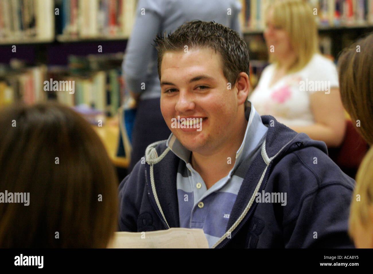 Male 6th form college student in college library Stock Photo - Alamy