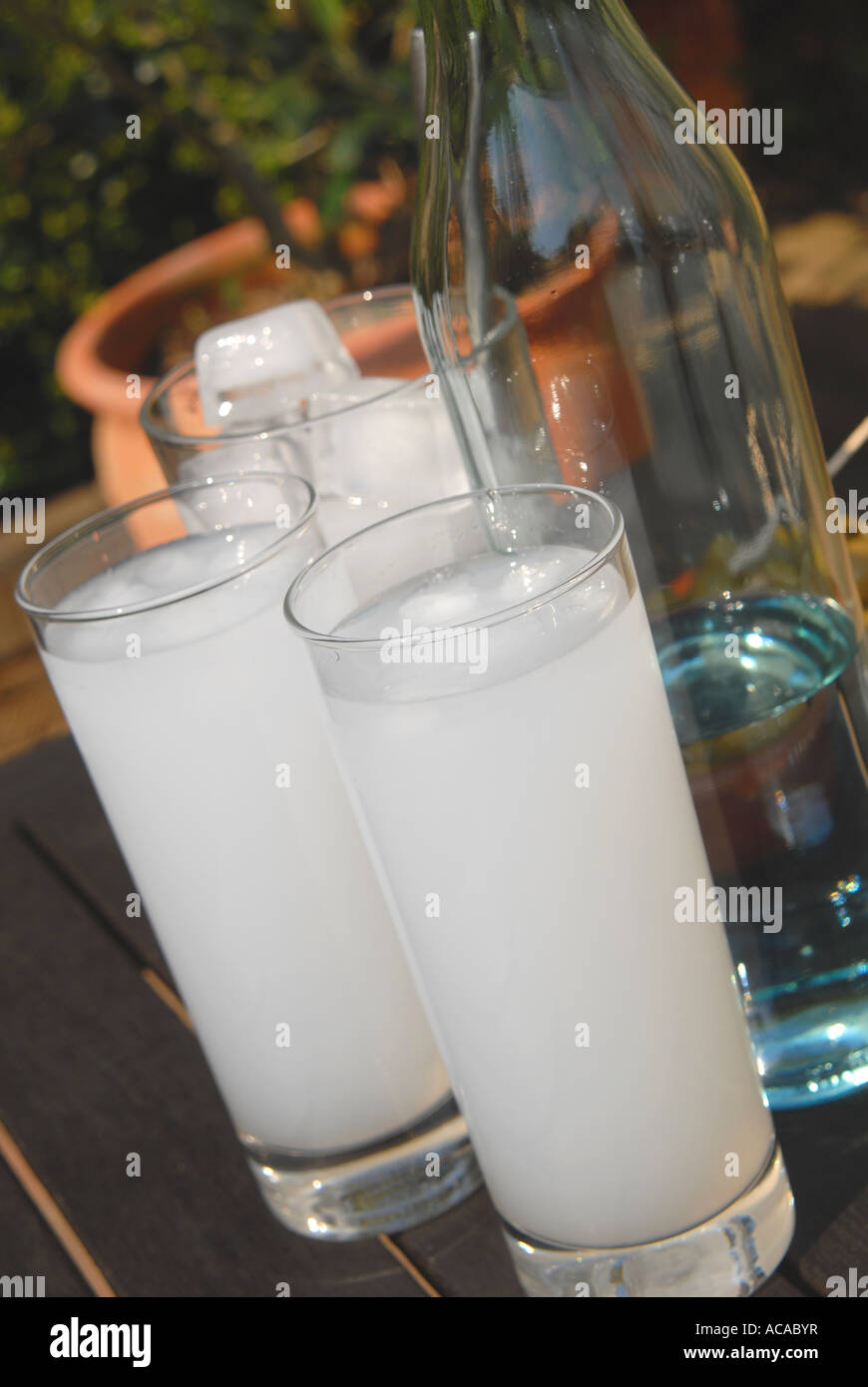GREECE Glasses of ouzo prepared the traditional way with water and ice ...