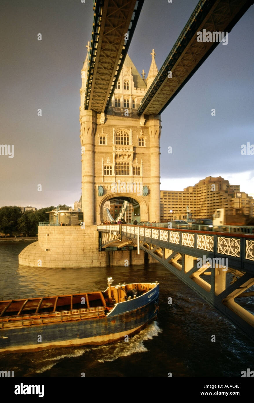 Tower Bridge bow of Thames freighter passing Storm clouds breaking up ...