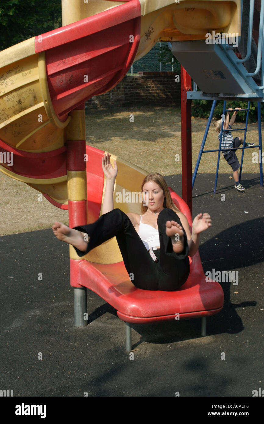 teenage girl playing on slide Stock Photo - Alamy