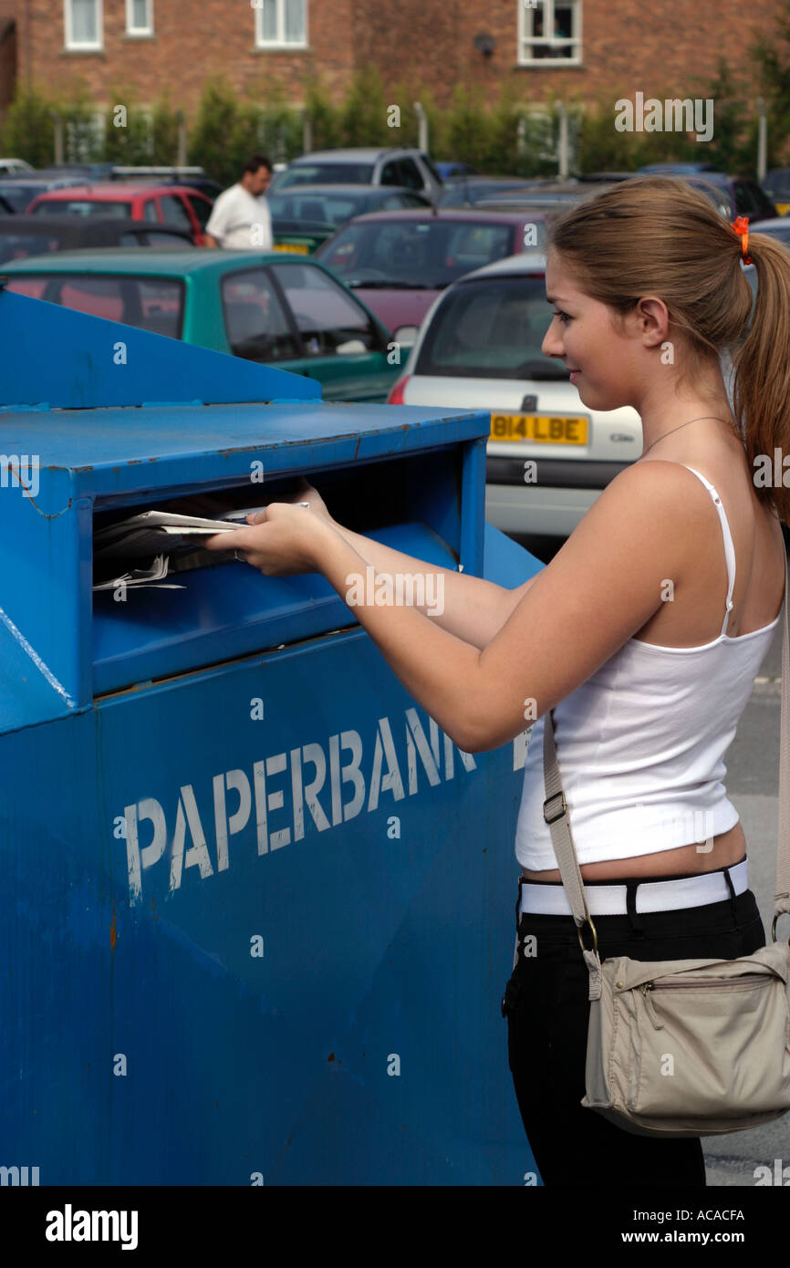Young Woman Putting Paper Into Paperbank Stock Photo - Alamy