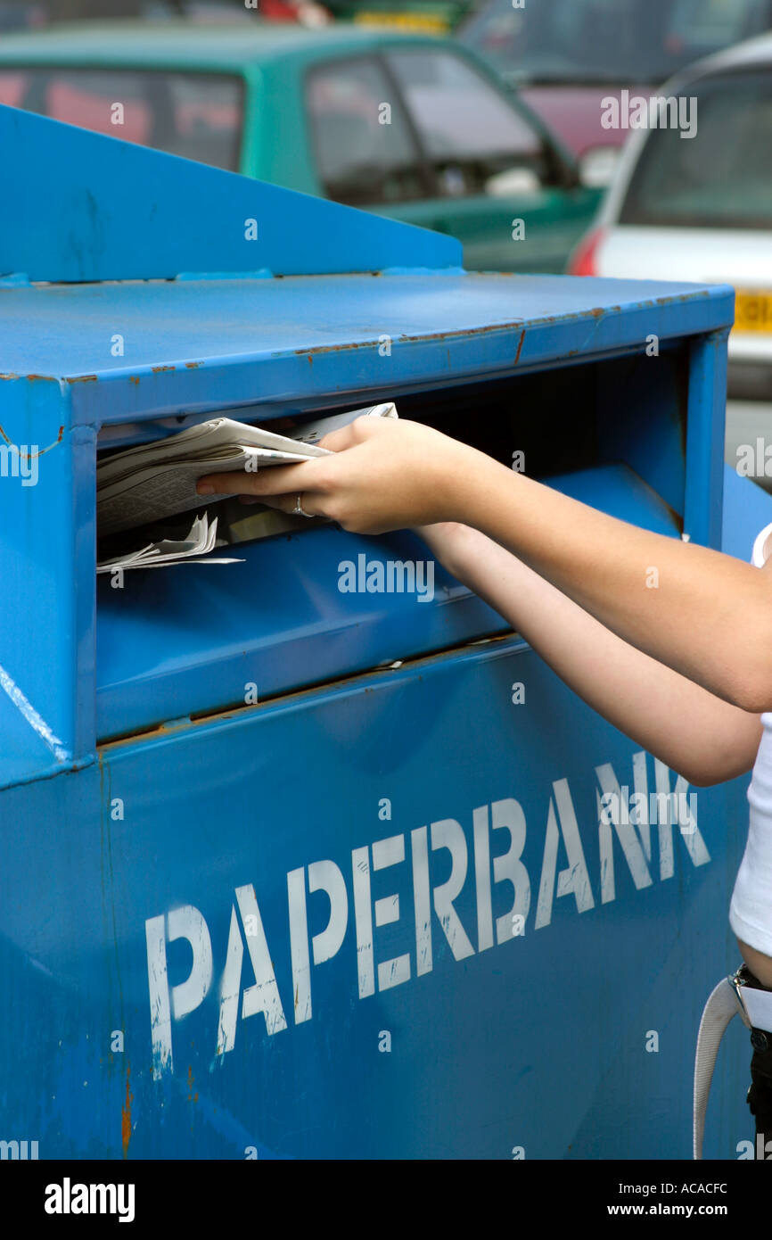 female putting paper into paperbank Stock Photo - Alamy