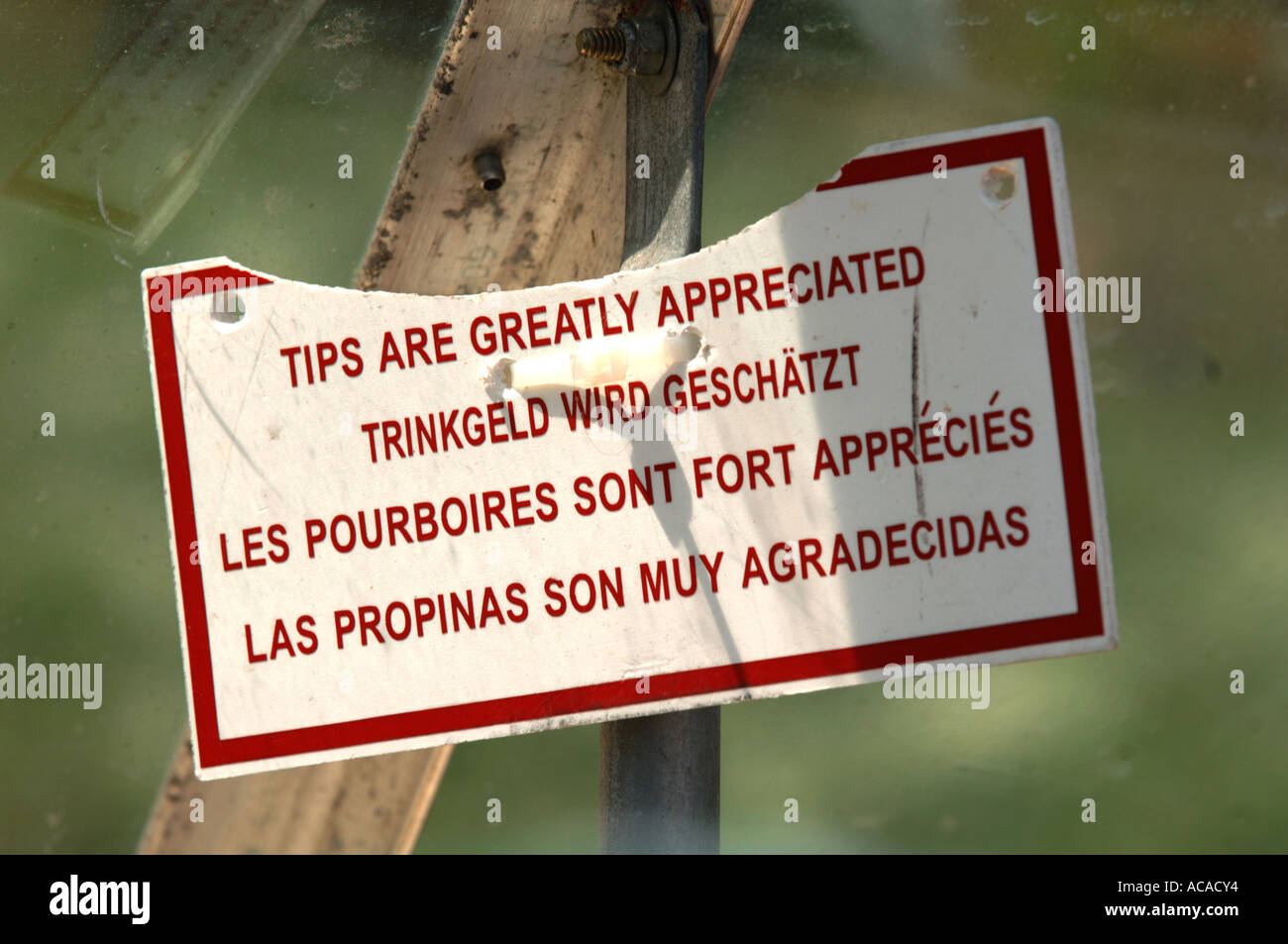 Tipping sign in several languages, USA Stock Photo - Alamy