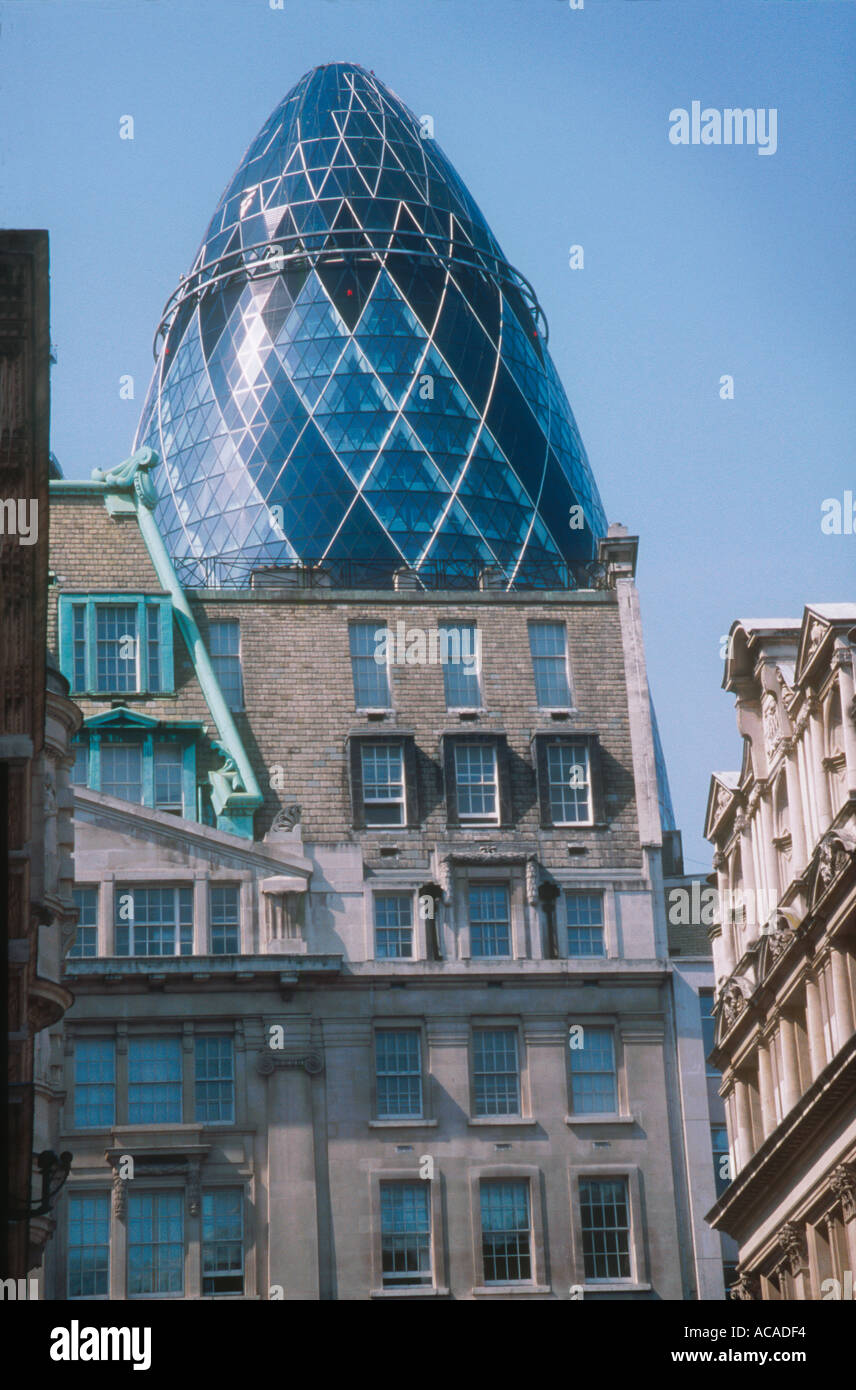 Swiss Re Tower behind old buildings City of London UK Stock Photo - Alamy