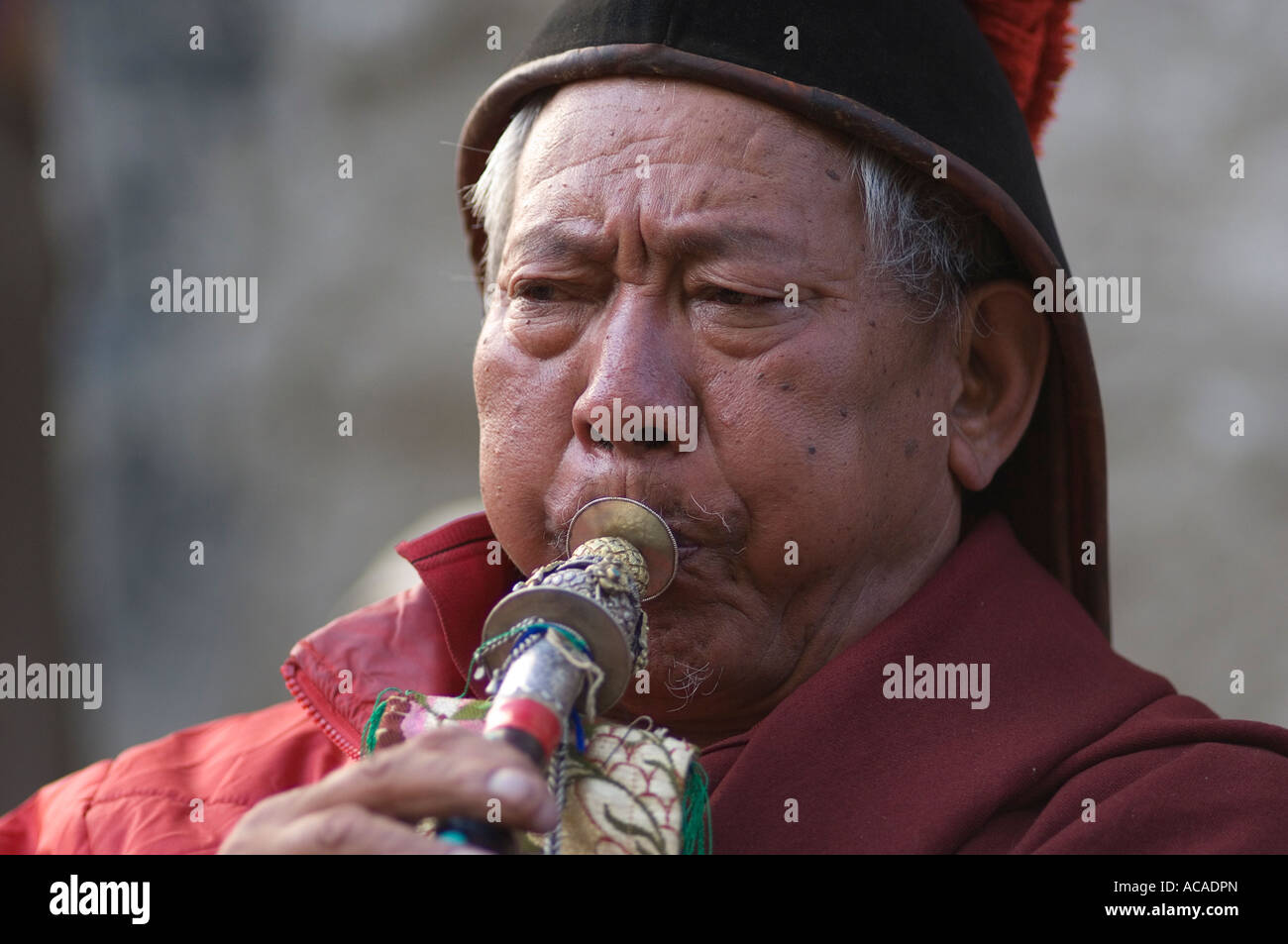 Portrait of Nepalese monk playing 'Geling' (short trumpet) Lo-Manthang ...