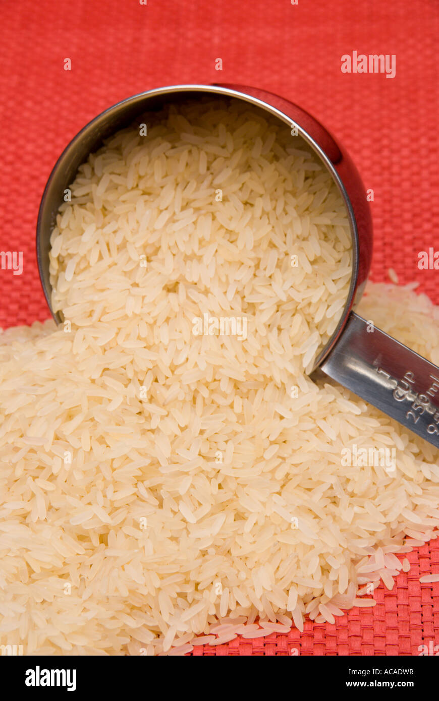 Still life rice grains close up with a Measuring cup Stock Photo - Alamy
