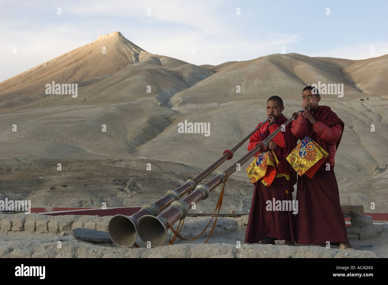 Two Nepalese monks playing the 'Lawa' (long trumpet) on the rooftop of ...