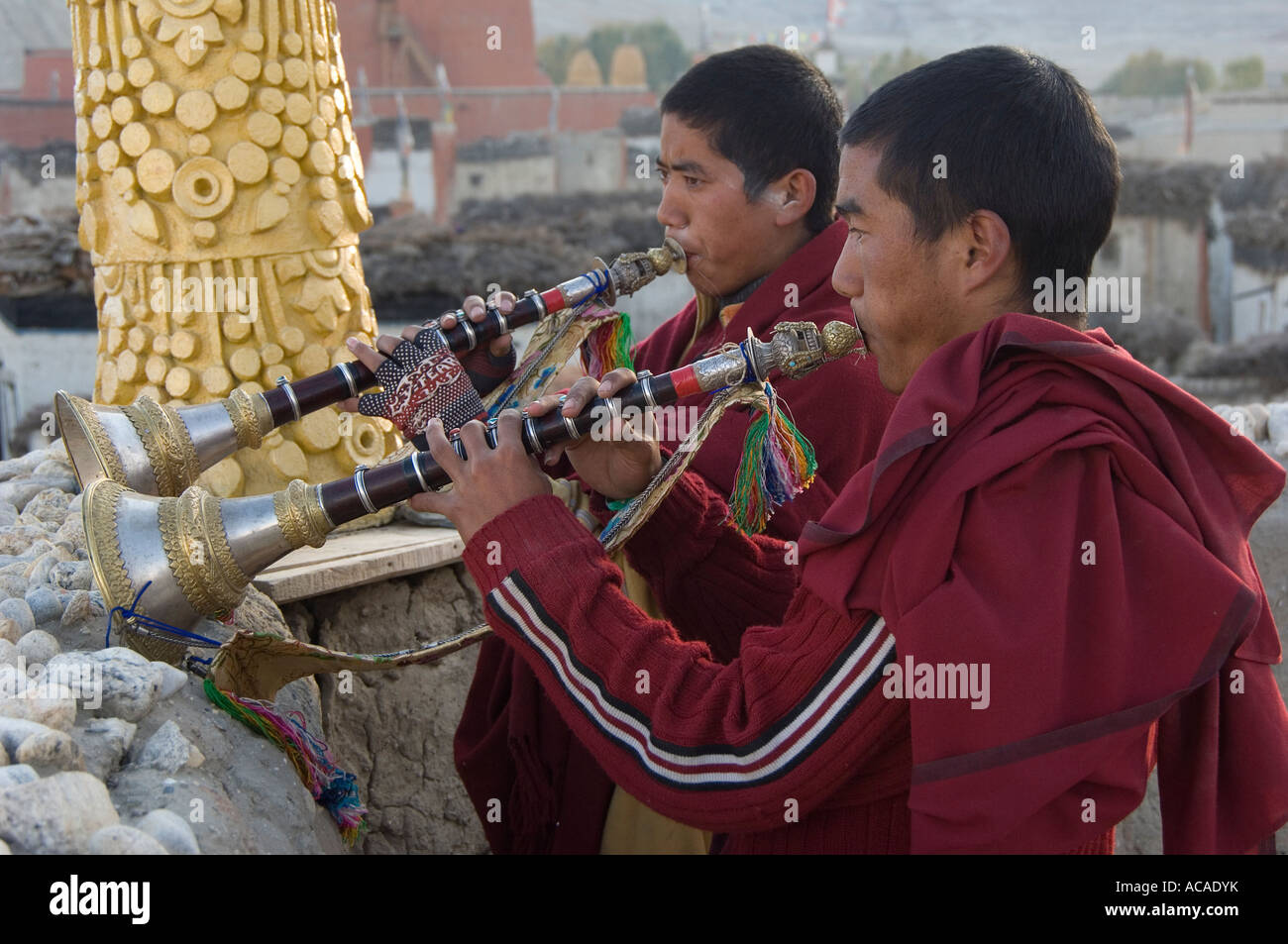 Two Nepalese monks playing the 'Geling' (short trumpet) on top of the ...