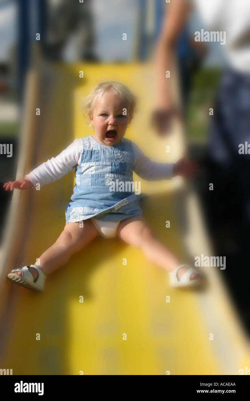 screaming young girl on slide Stock Photo - Alamy
