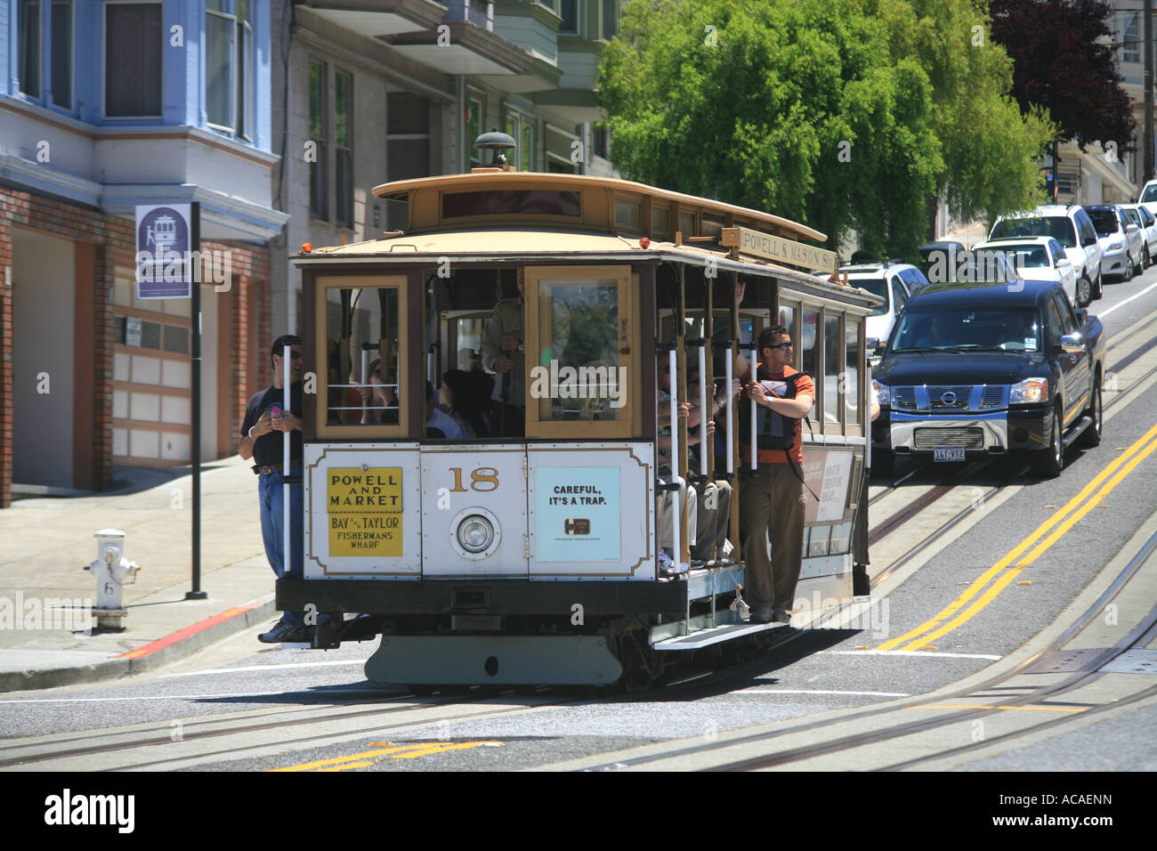 Cable Car with tourists in the open doors on the steep streets in the ...