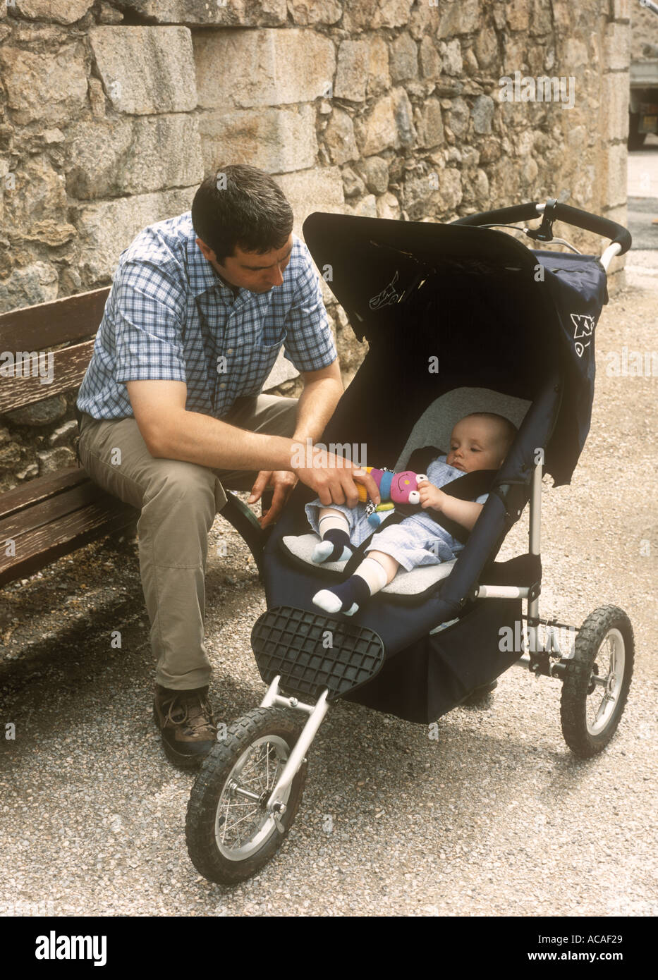 Father looking at his baby son in a buggy, France Stock Photo - Alamy