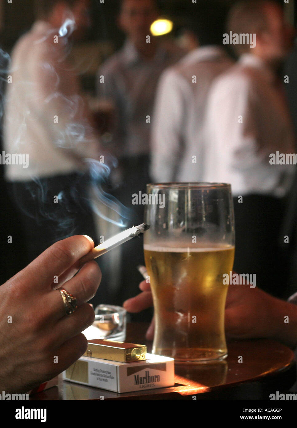 Holding beer cigarette hi-res stock photography and images - Alamy