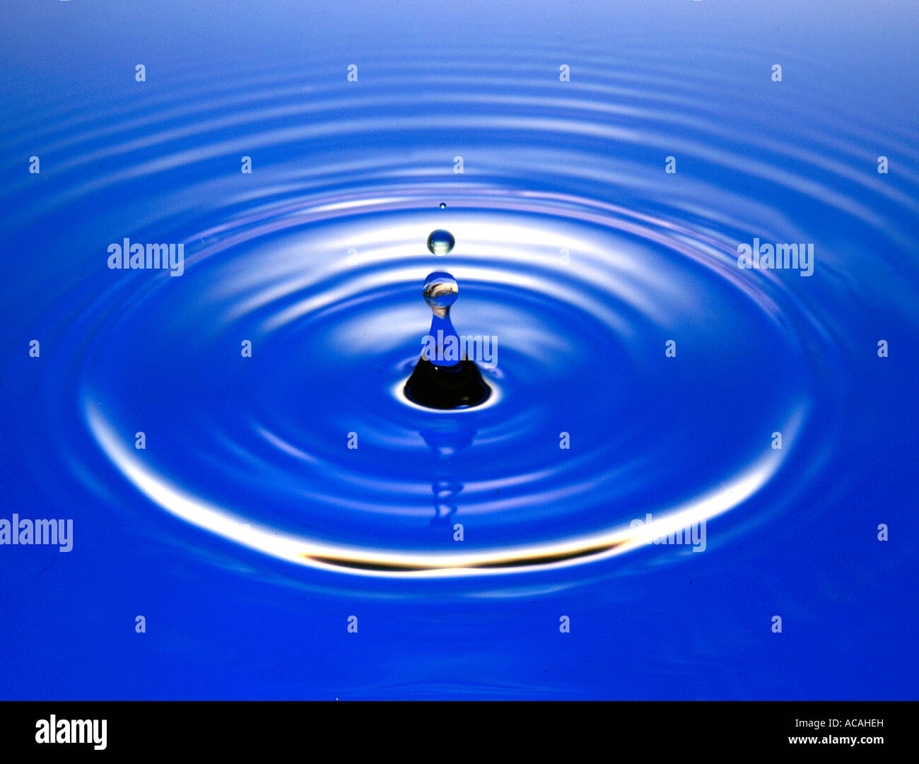Drop falls on the water surface Stock Photo - Alamy