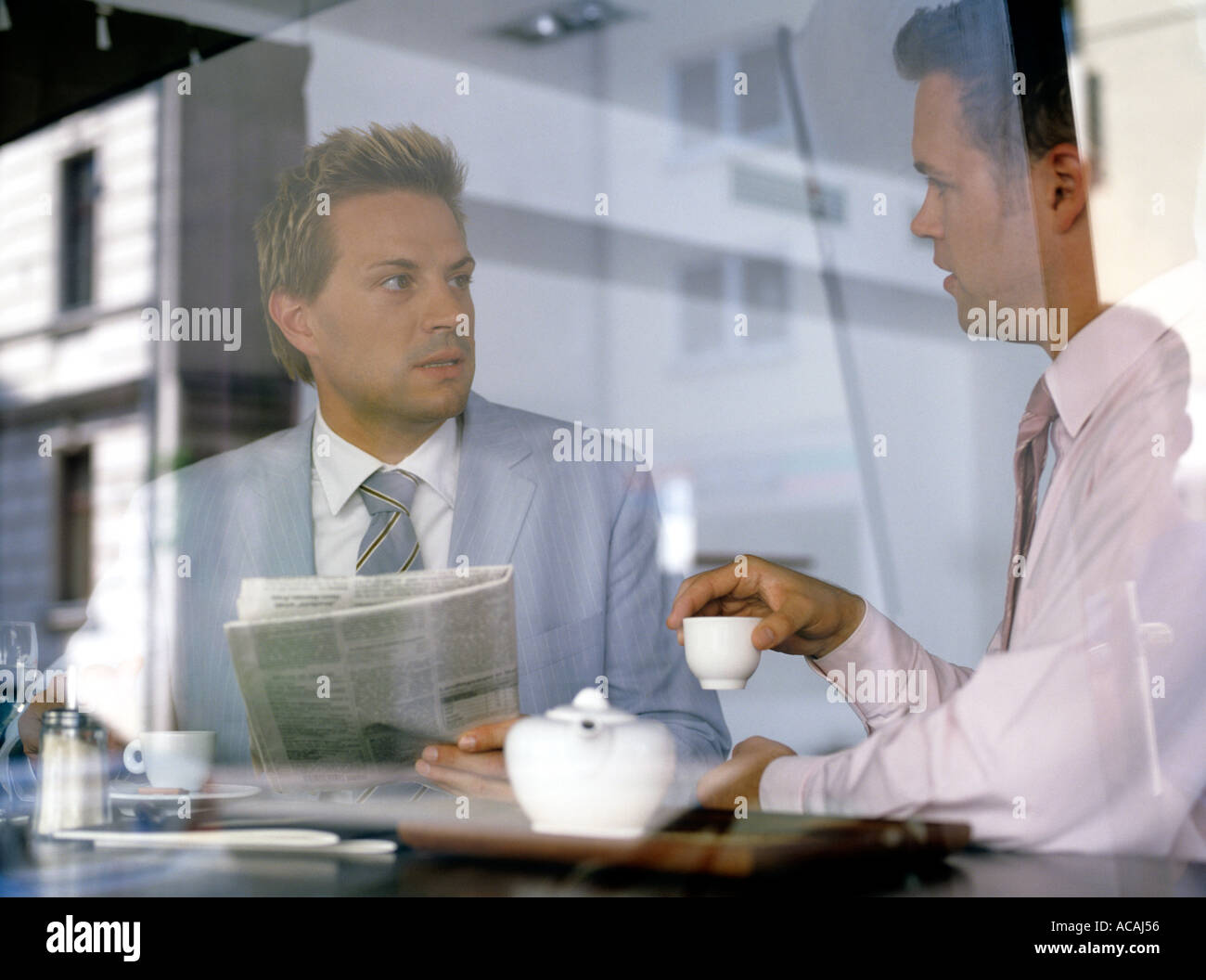 businessmen having a conversation in a cafe Stock Photo - Alamy