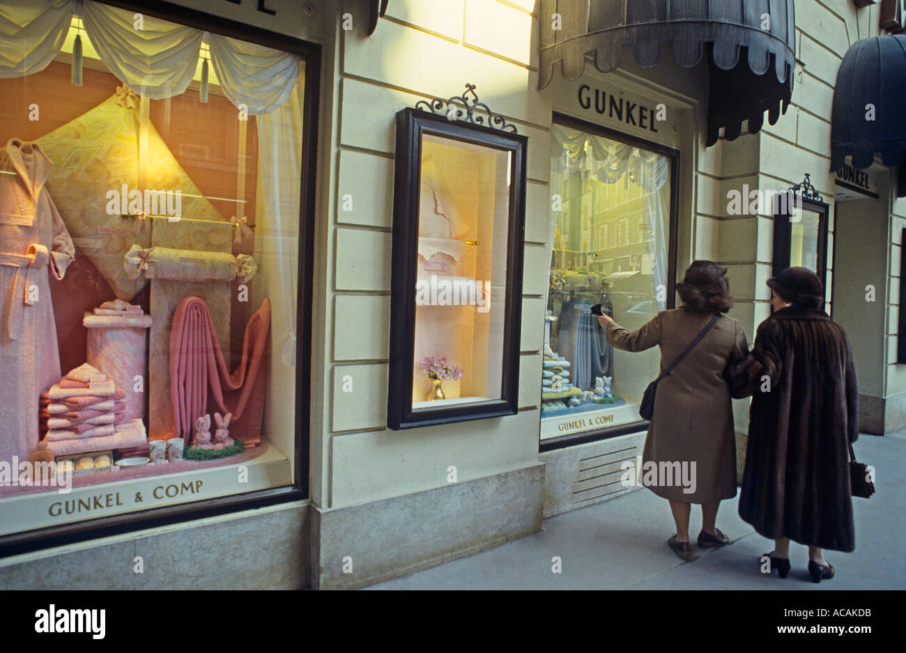 Elegant older ladies pause to look into one of many stylish luxury ...