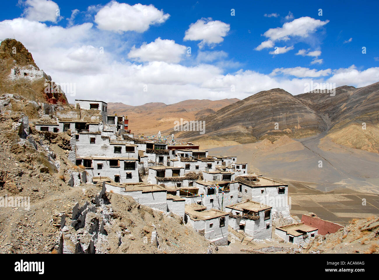 Mountain and monastery Shegar with white washed walls situated at the ...