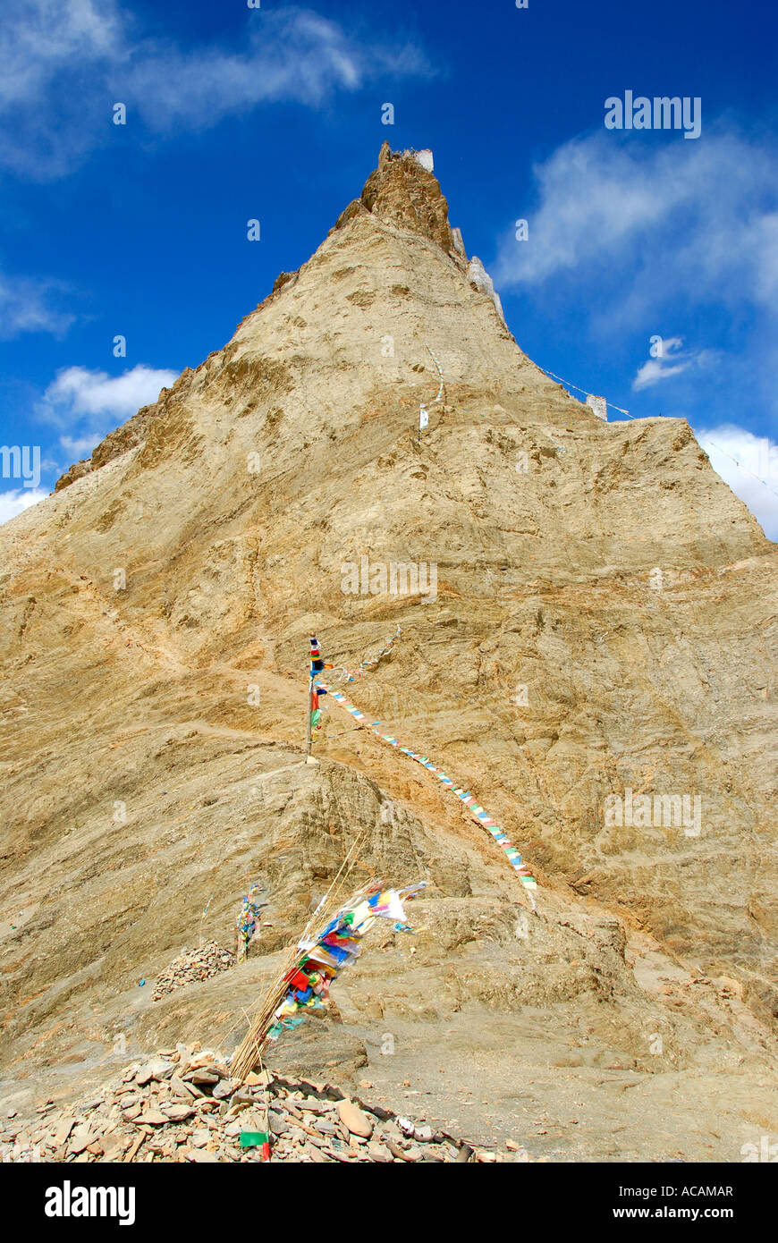 Old fortress dzong on the mountain with colourful prayer flags in the ...