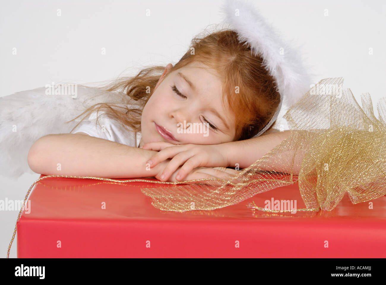 Little christmas angel with a christmas present Stock Photo - Alamy