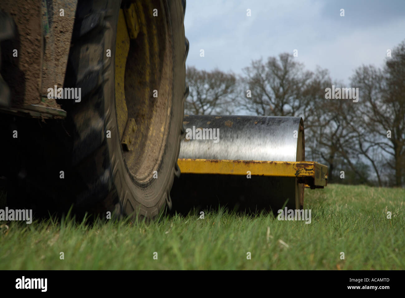 Tractor rolling hay field 1 Stock Photo - Alamy
