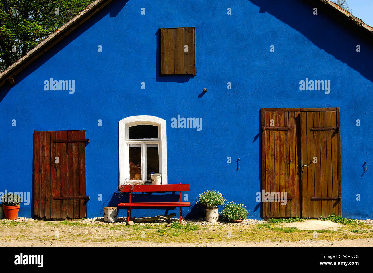 Blue house with white-framed window Stock Photo - Alamy