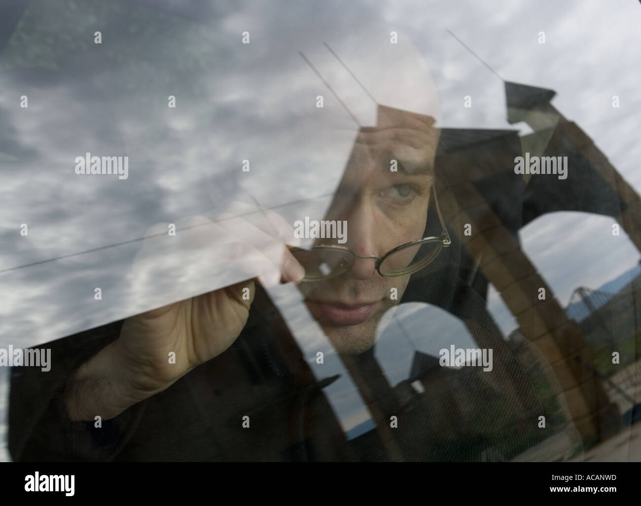 Man watching trough a glass window Stock Photo - Alamy