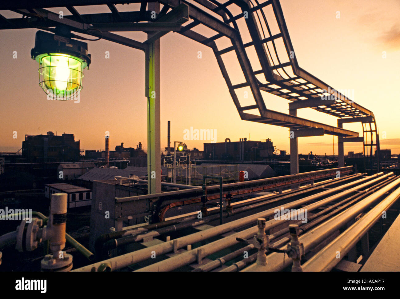 Industrial pipework in chemical factory complex at sunset Stock Photo ...