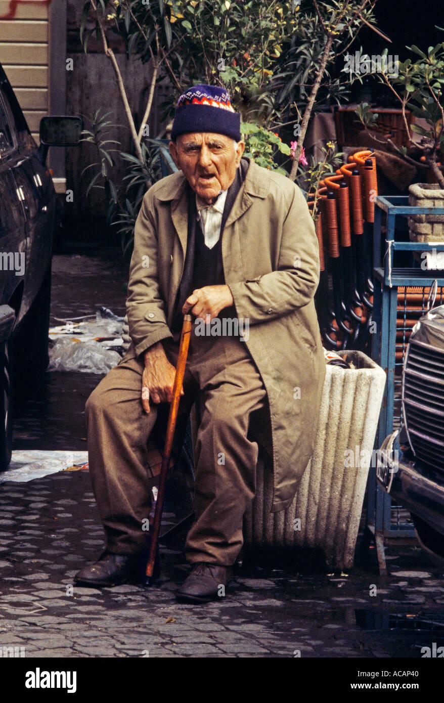 Elderly disabled man sitting alone in city center Stock Photo - Alamy