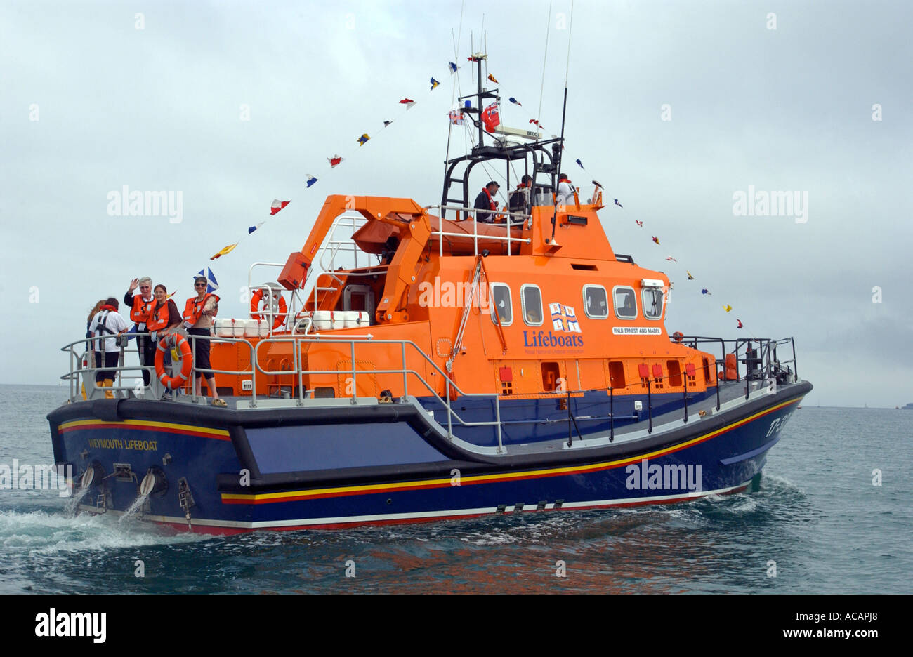 RNLI lifeboat with decoration flags displayed, Weymouth harbour Dorset ...