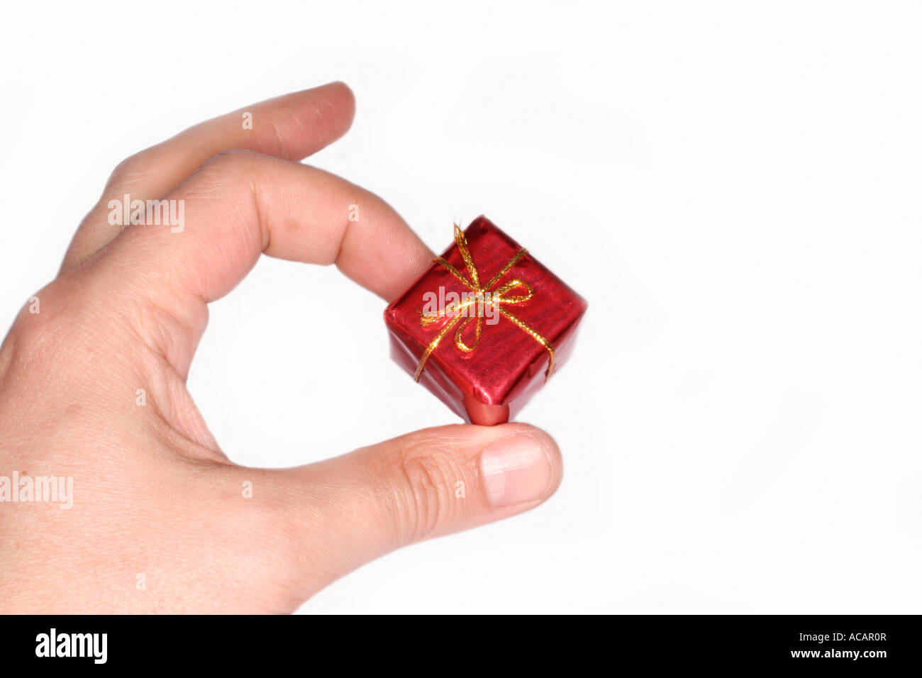 Hand holding a tiny package Stock Photo - Alamy