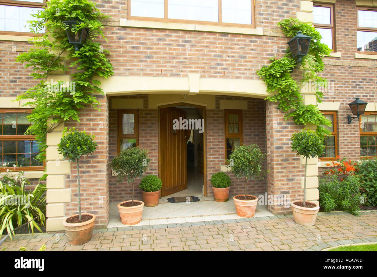 Front exterior of large detached house with mature gardens Stock Photo ...