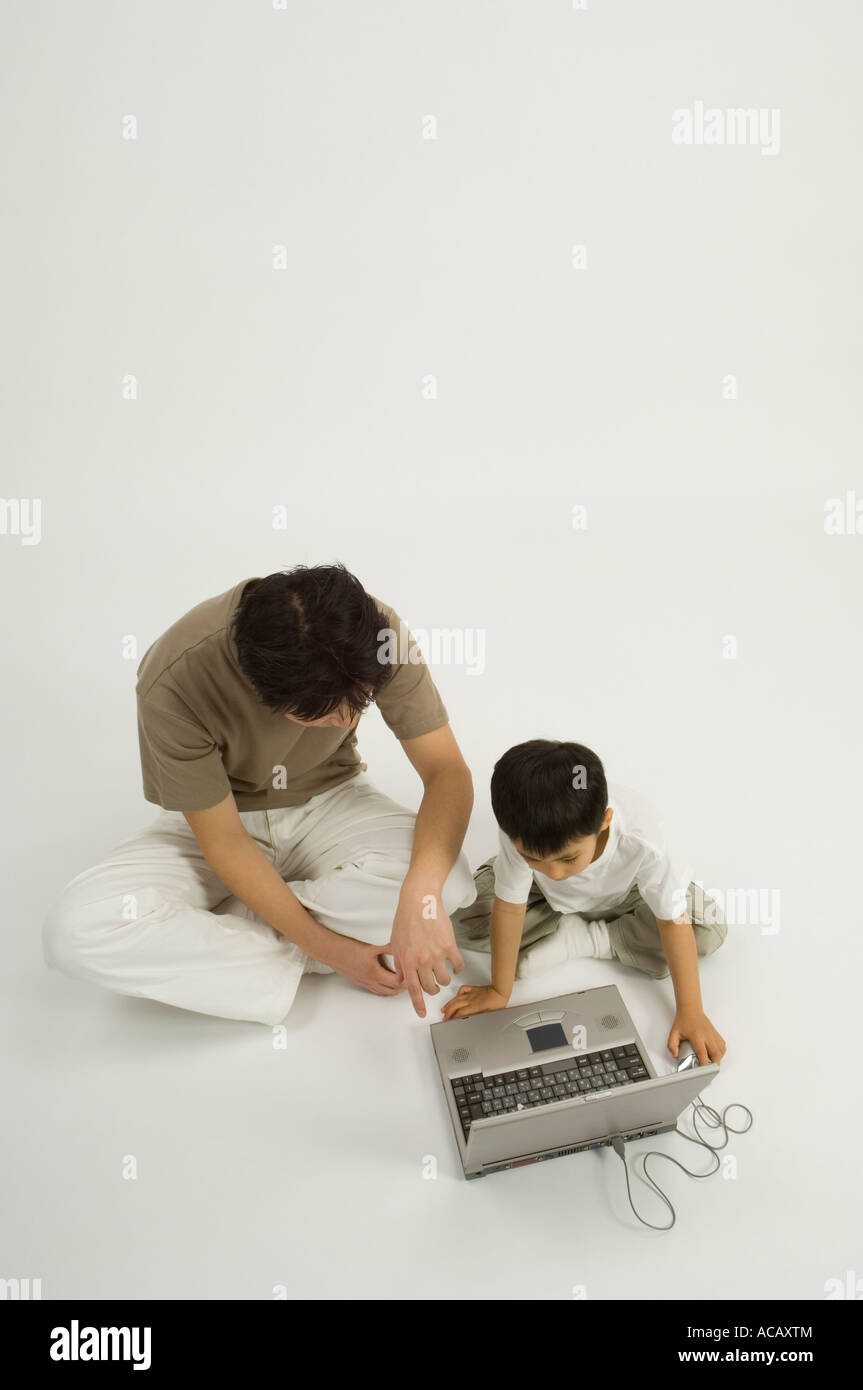 Father and son using computer Stock Photo - Alamy