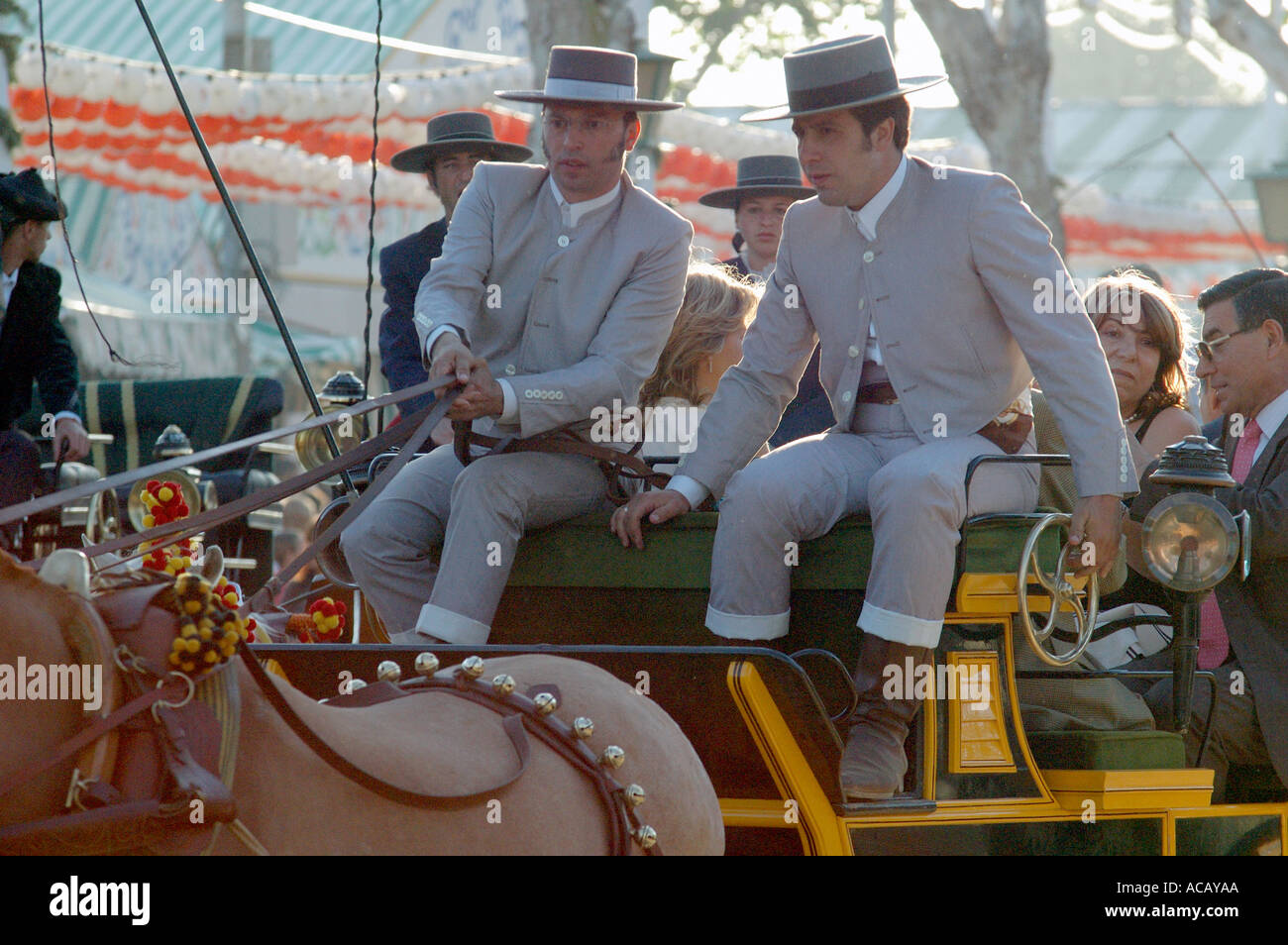 Coachmen in traditional uniform with sombreros driving through the ...