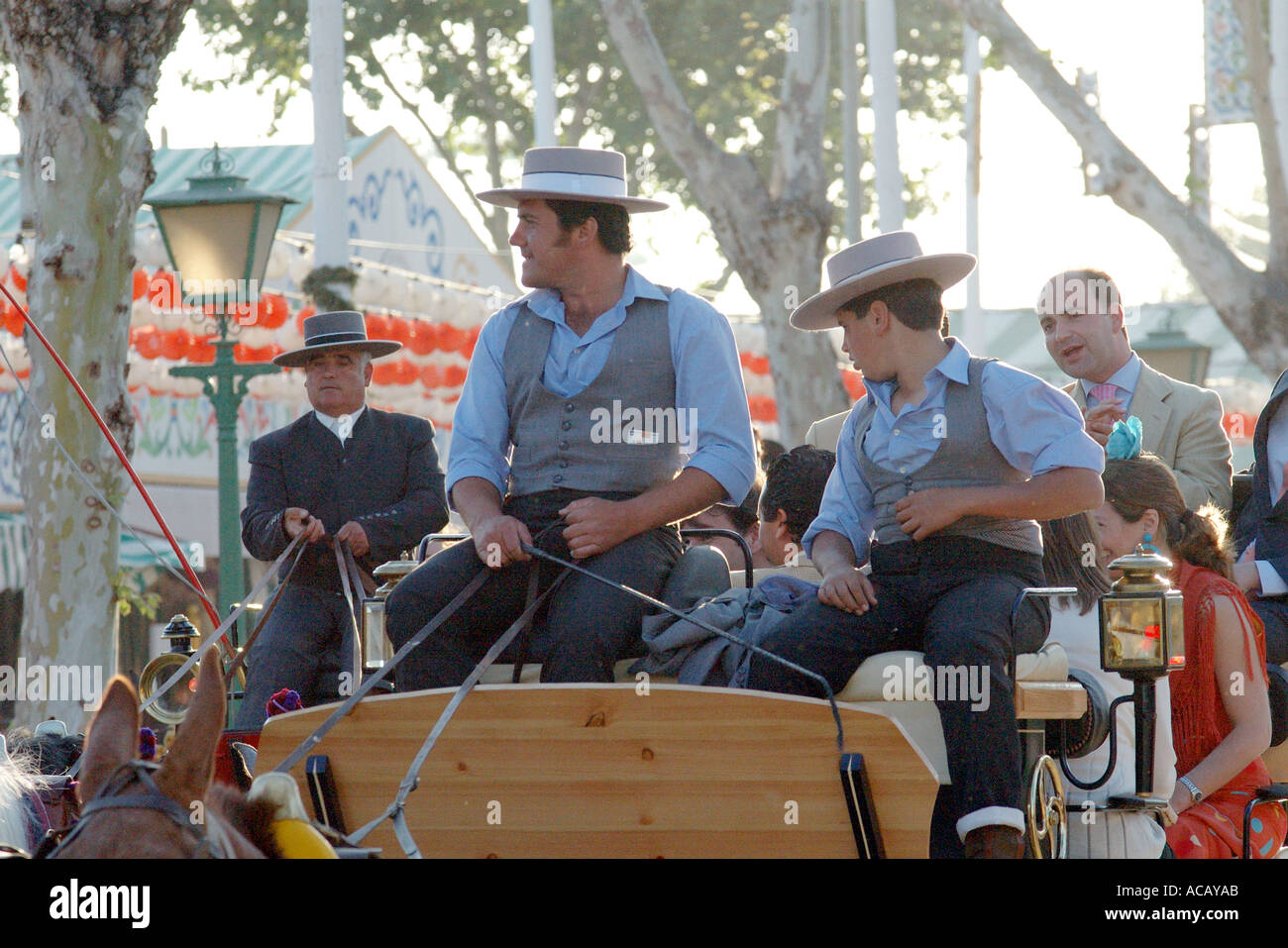 Coachmen in traditional uniform with sombreros driving through the ...