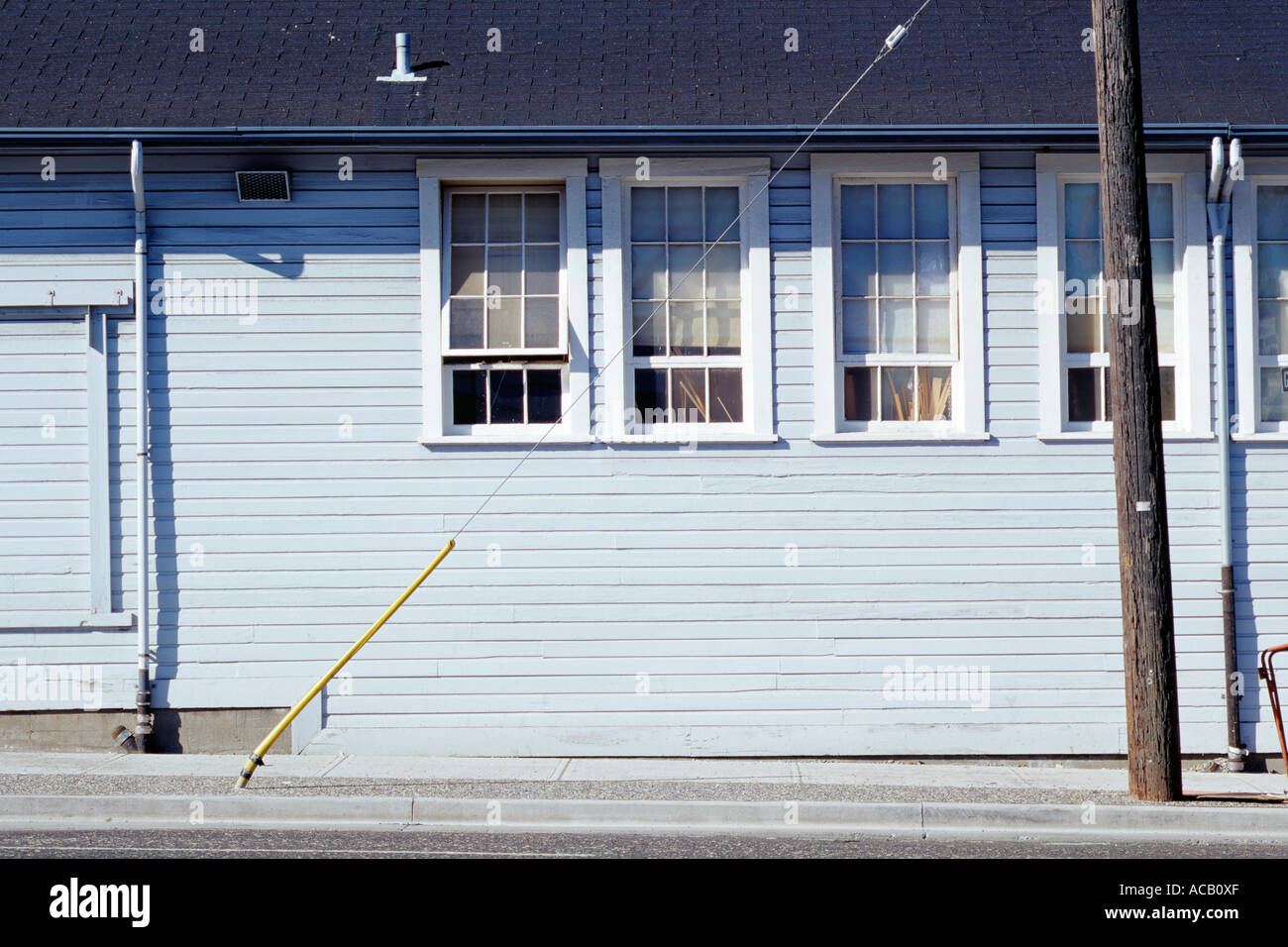 Warehouse exterior wall with windows hydro utility pole sidewalk Stock ...