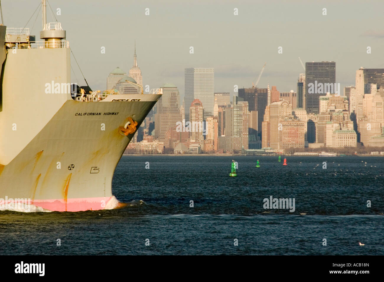 View of New York Skyline with Container Ship passing Stock Photo - Alamy