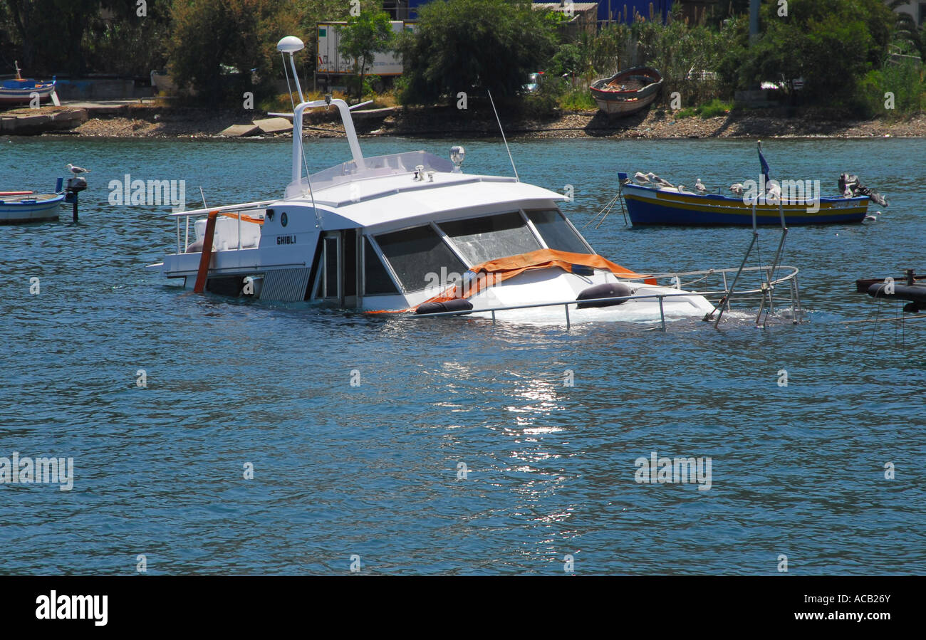 sunken pleasure boat in Cefalu harbout, Sicily Stock Photo - Alamy