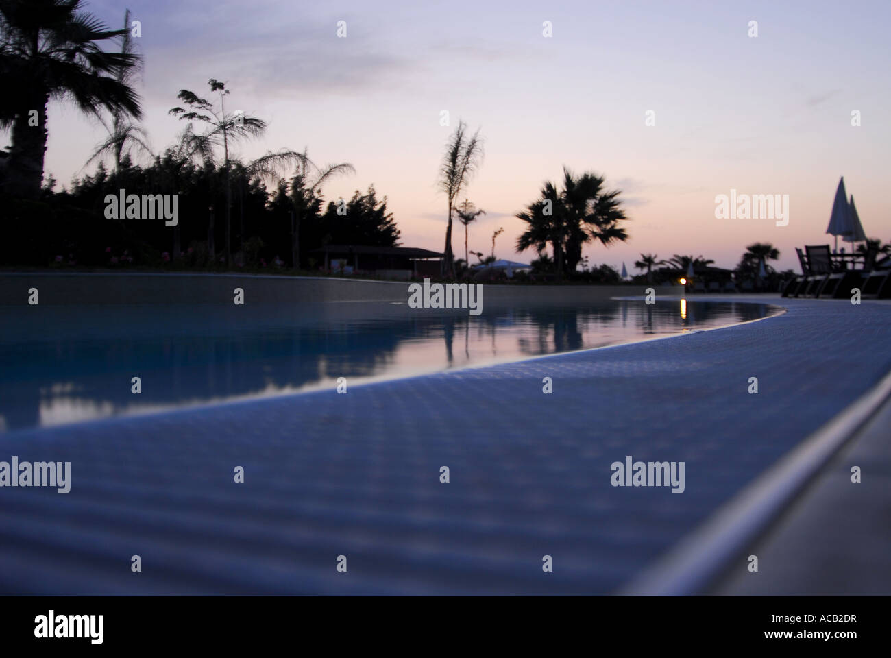 Hotel swimming pool still at dusk Stock Photo - Alamy