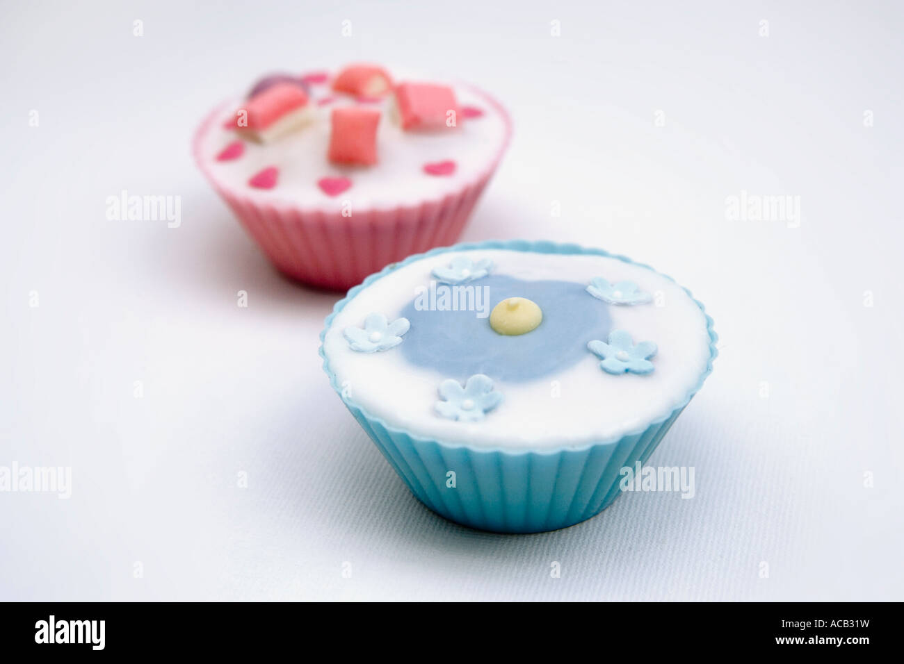 Two cup cakes against white background Stock Photo - Alamy