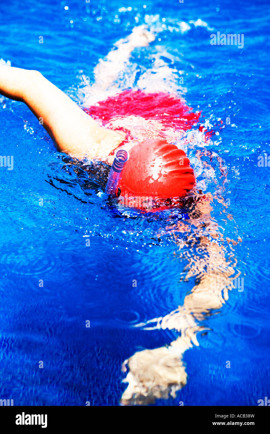 Woman swimming in red costume Stock Photo - Alamy