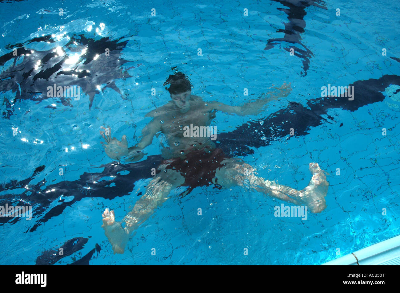Man diving in swimming pool Stock Photo - Alamy