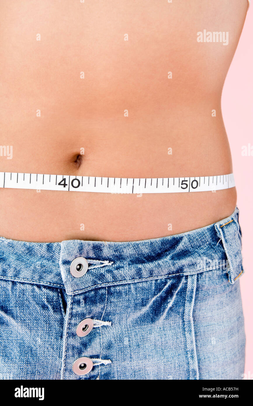 Woman measuring her waist Stock Photo - Alamy Woman measuring her waist Stock Photo - Alamy