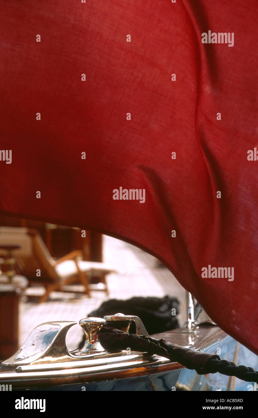 Detail of ships stern mooring rope and red flag Stock Photo - Alamy