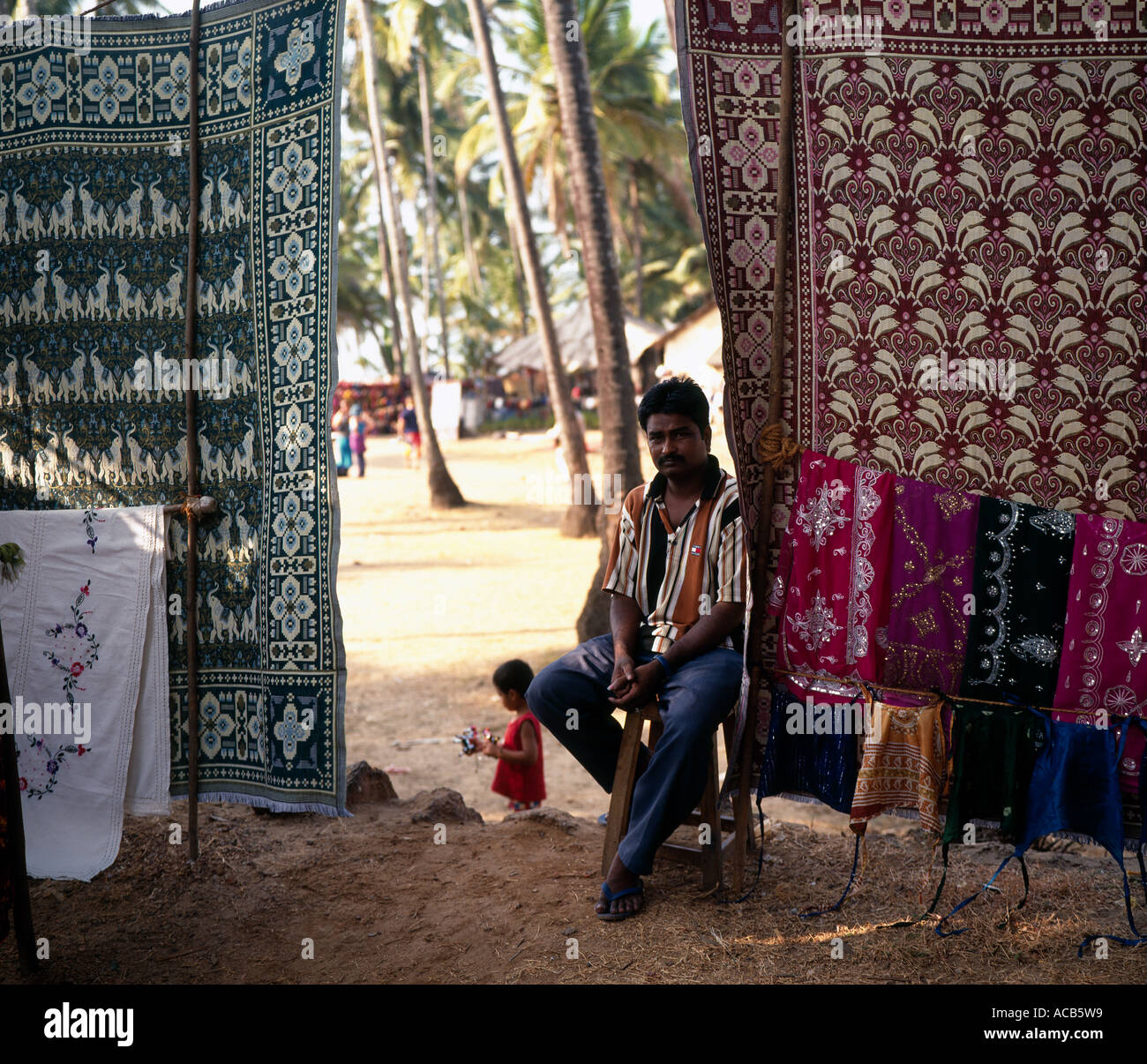 clothes stall and stallholder at Anjuna hippy market, Goa, India Stock ...