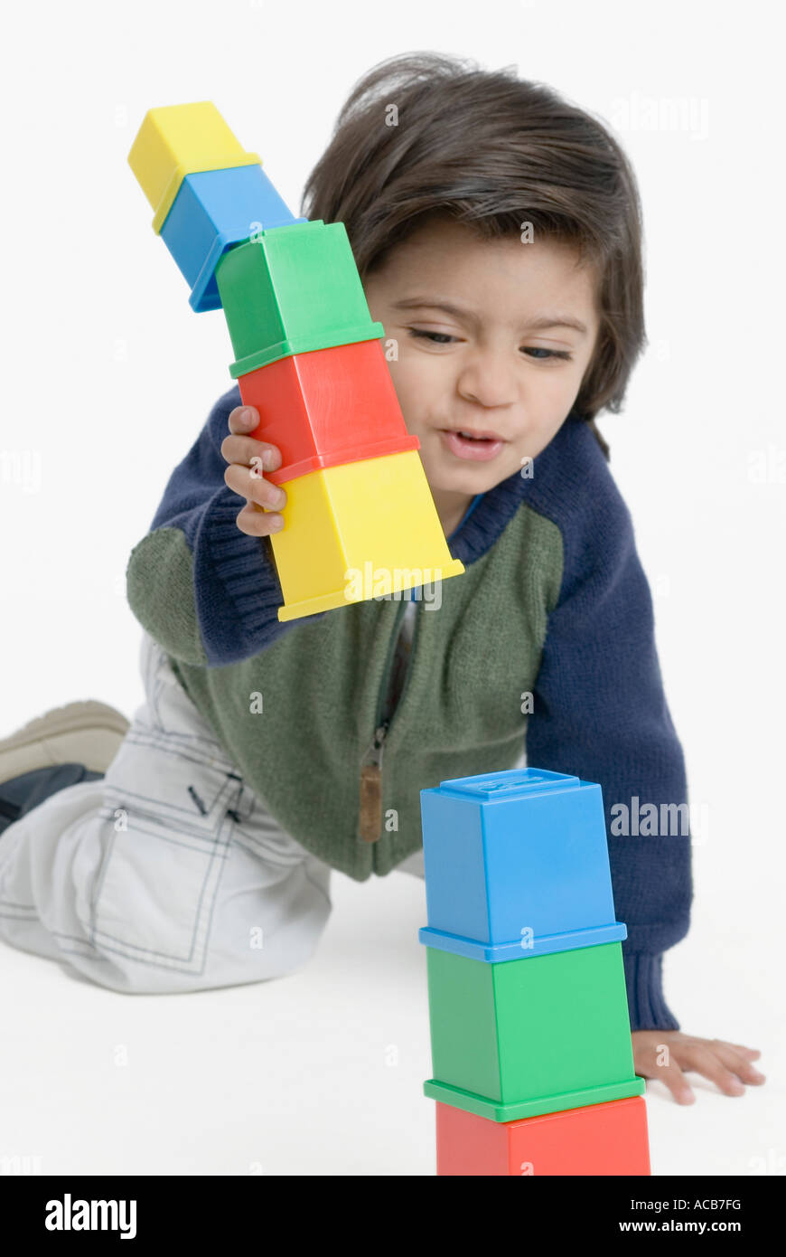 Boy playing with plastic blocks Stock Photo - Alamy