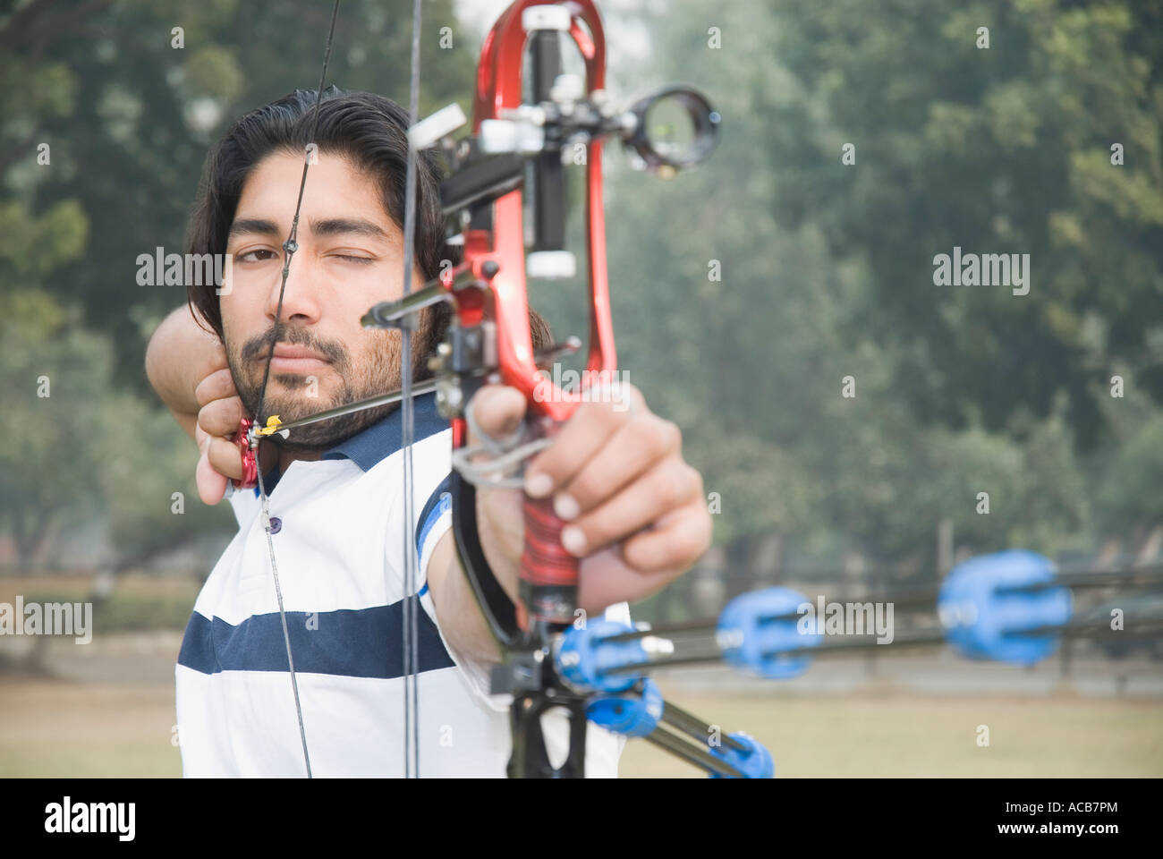 Close Up Of A Young Man Aiming With A Bow And Arrow Stock Photo Alamy