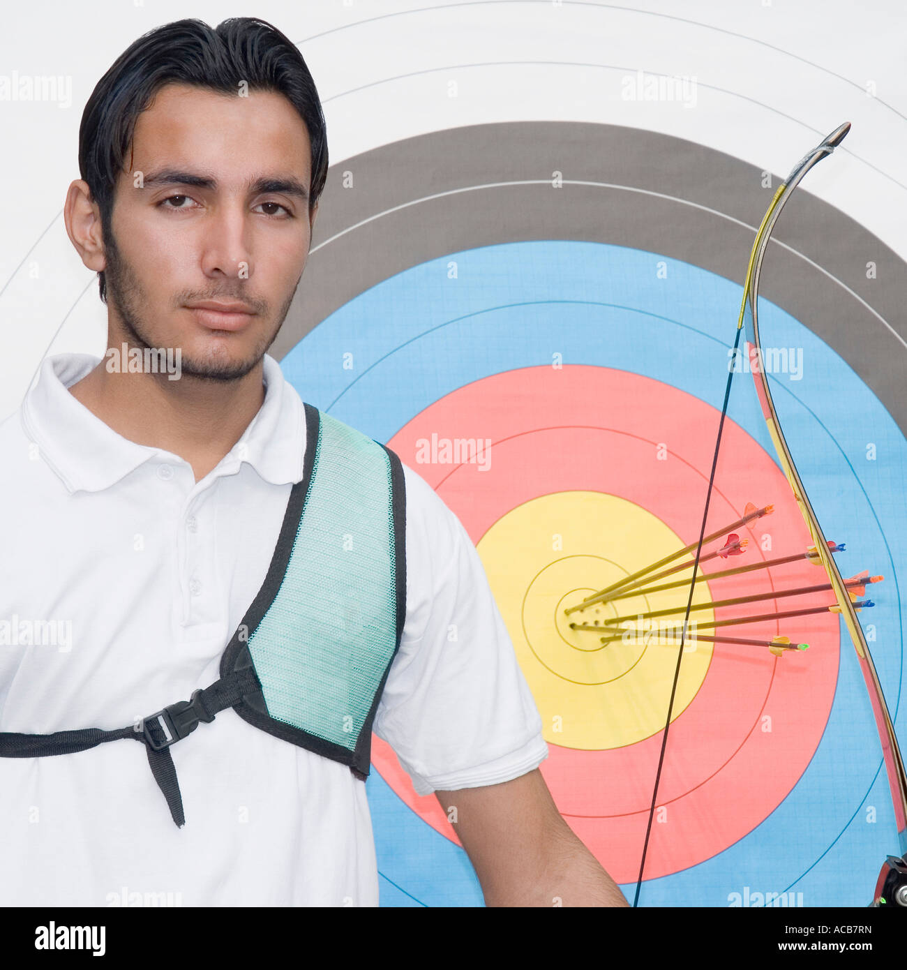 Portrait of a young man standing in front of bull's-eye Stock Photo - Alamy