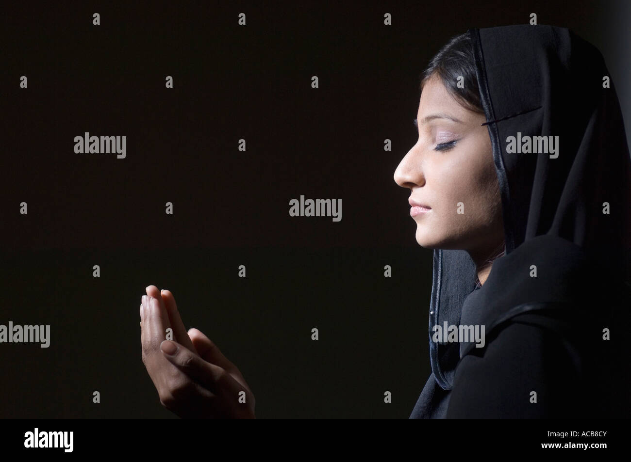 Side profile of a young woman praying Stock Photo - Alamy
